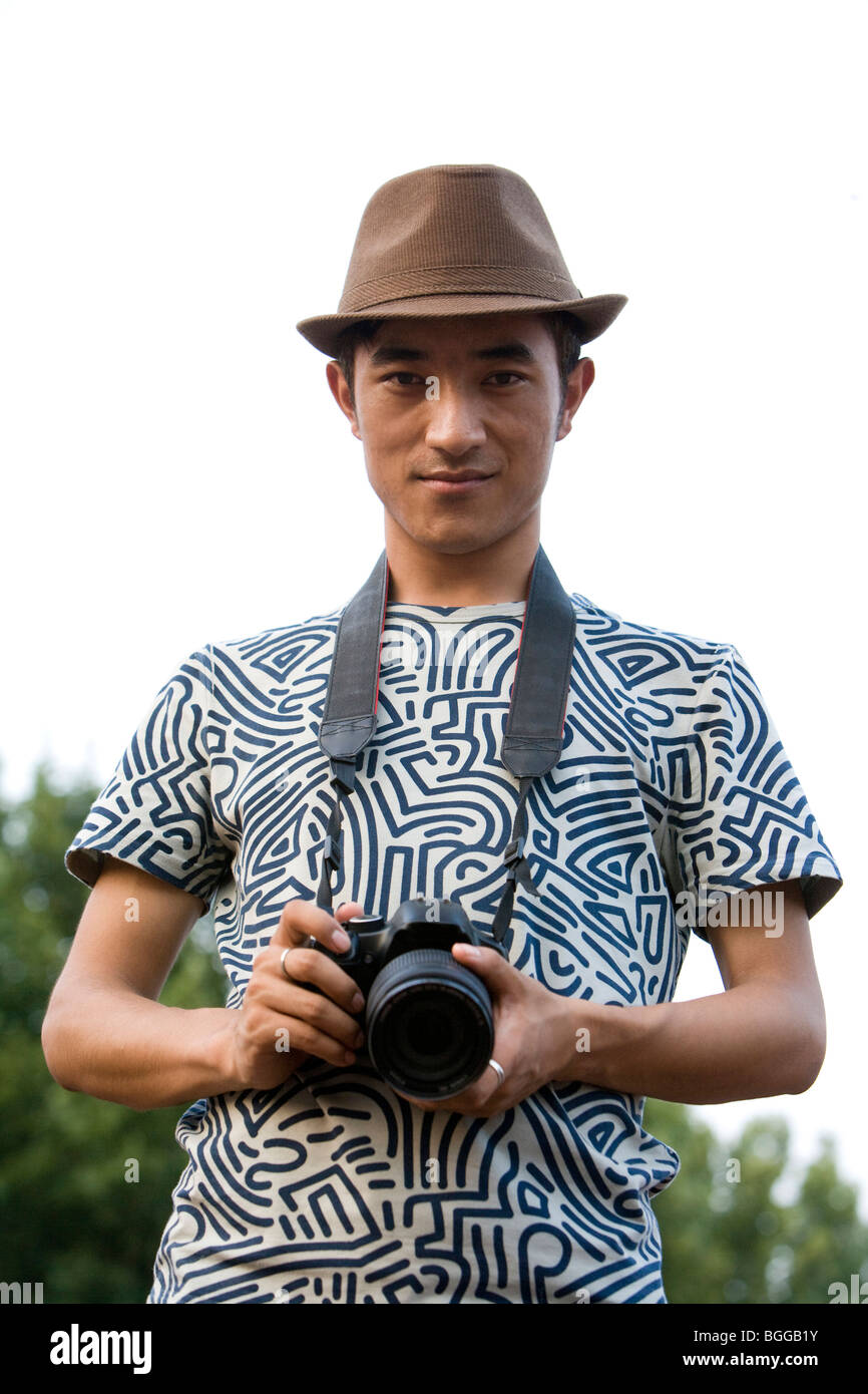 Young man using camera Stock Photo - Alamy