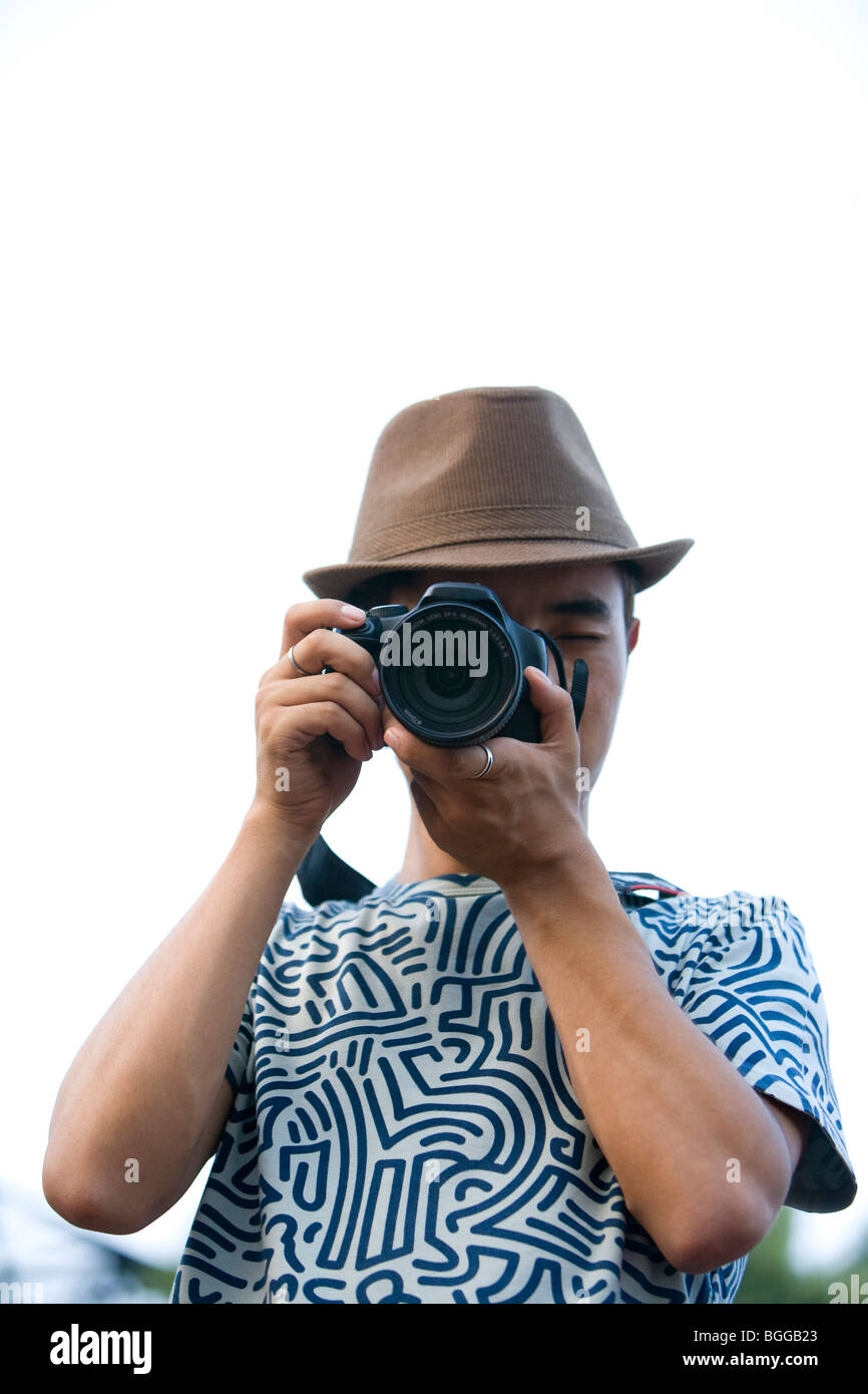 Young man using camera Stock Photo - Alamy