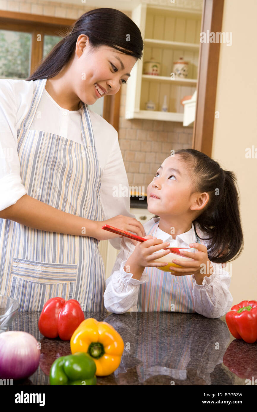 A family of three cooking in kitchen Stock Photo - Alamy