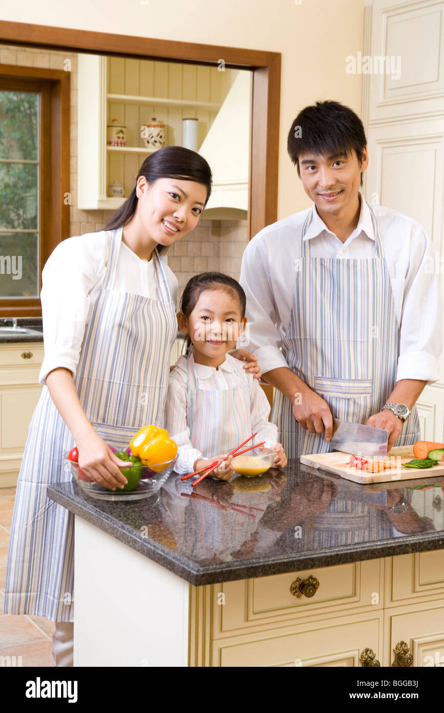 A family of three cooking in kitchen Stock Photo - Alamy