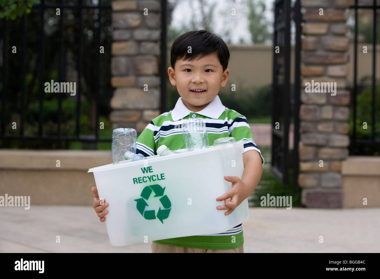 Little boy holding recycling box Stock Photo - Alamy