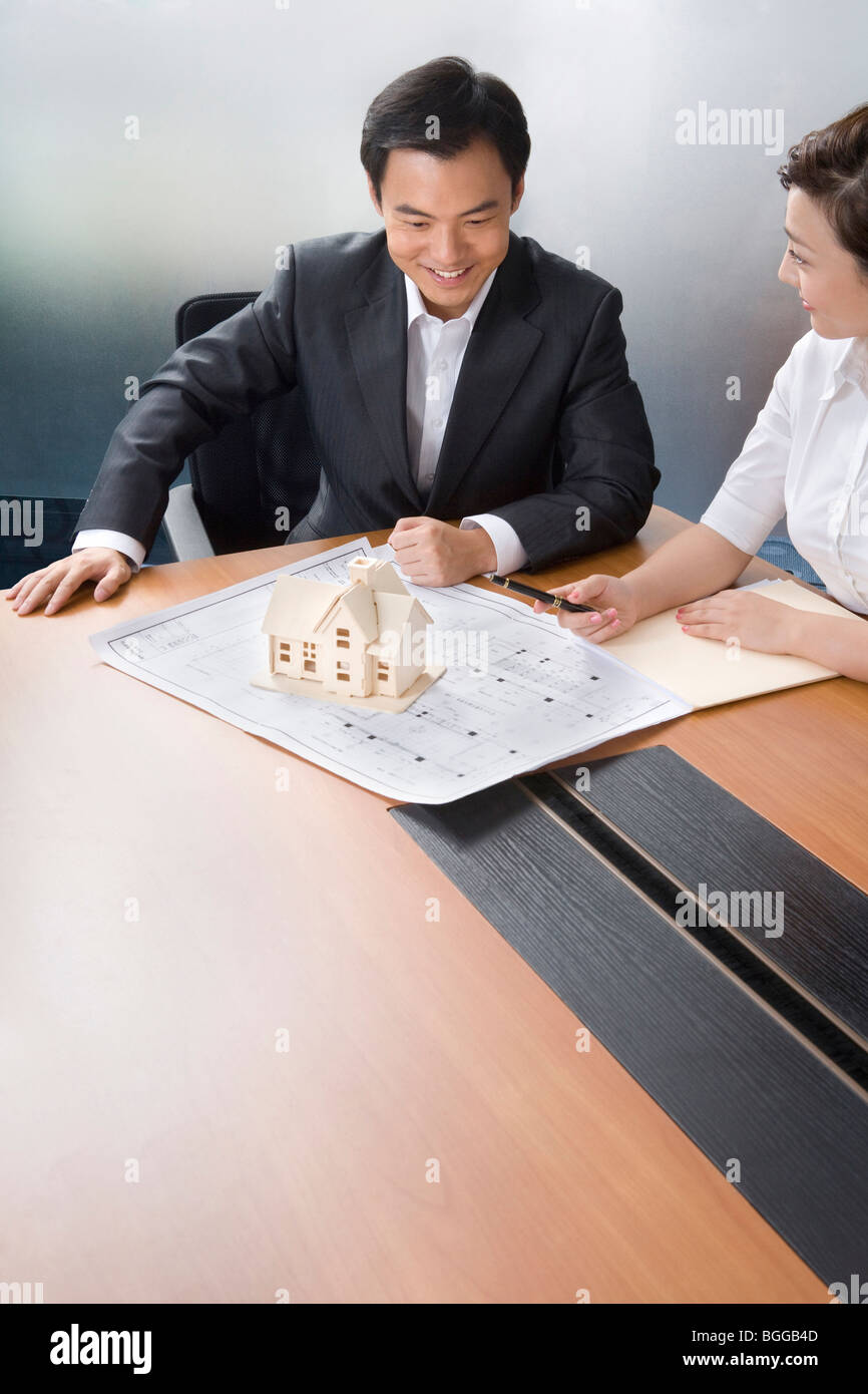 Businessmen with house model Stock Photo - Alamy