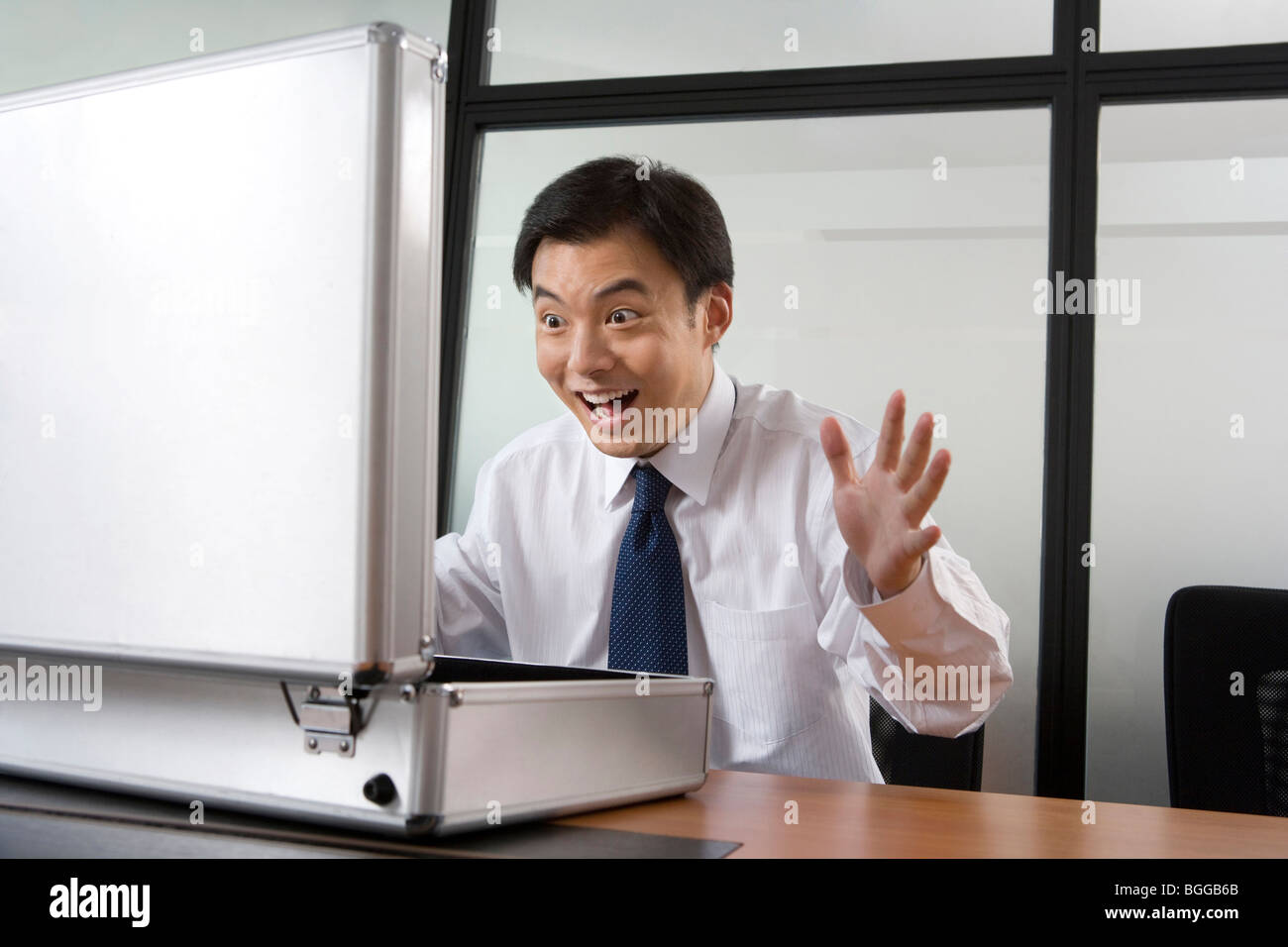 Young businessman opening a case with big surprise Stock Photo - Alamy