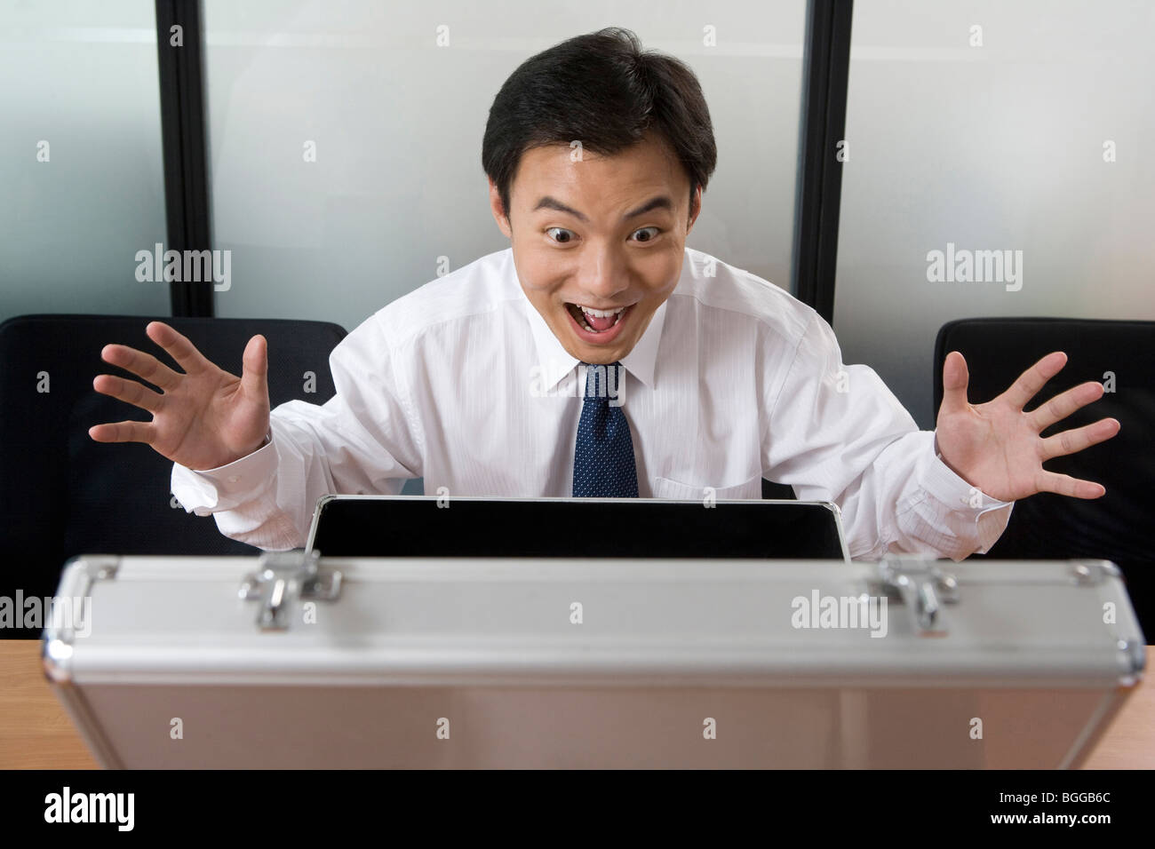 Young businessman opening a case with big surprise Stock Photo - Alamy