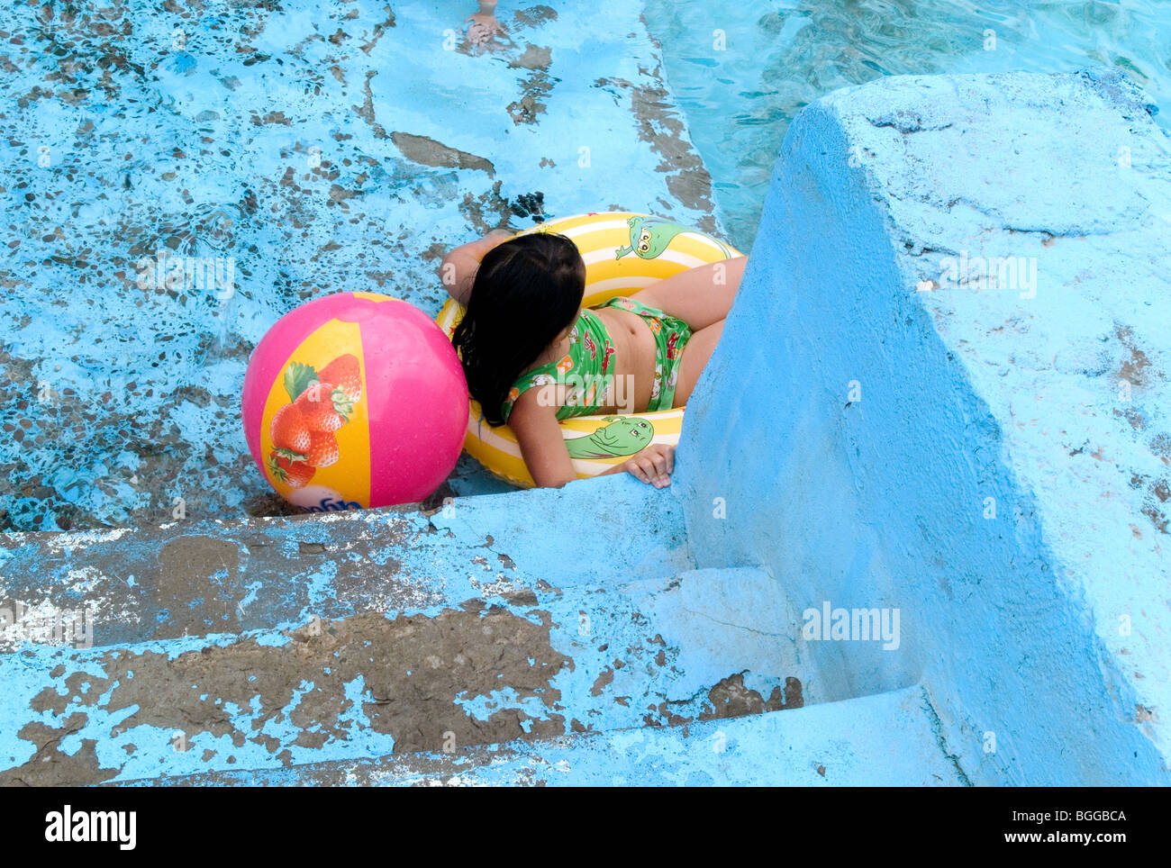 A girl floats on a rubber ring in a swimming pool Stock Photo - Alamy