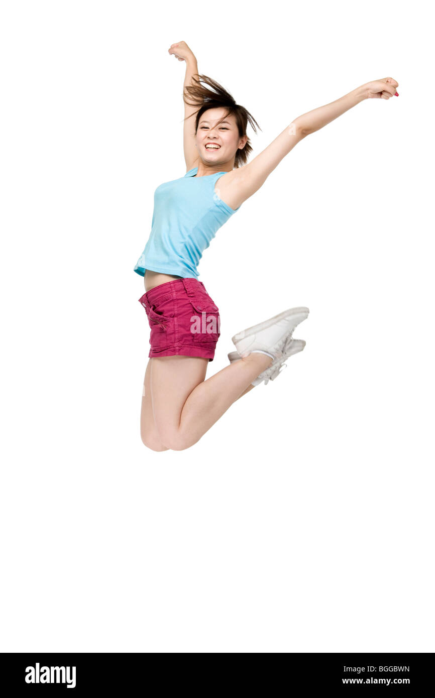 Young woman jumping in mid-air Stock Photo - Alamy