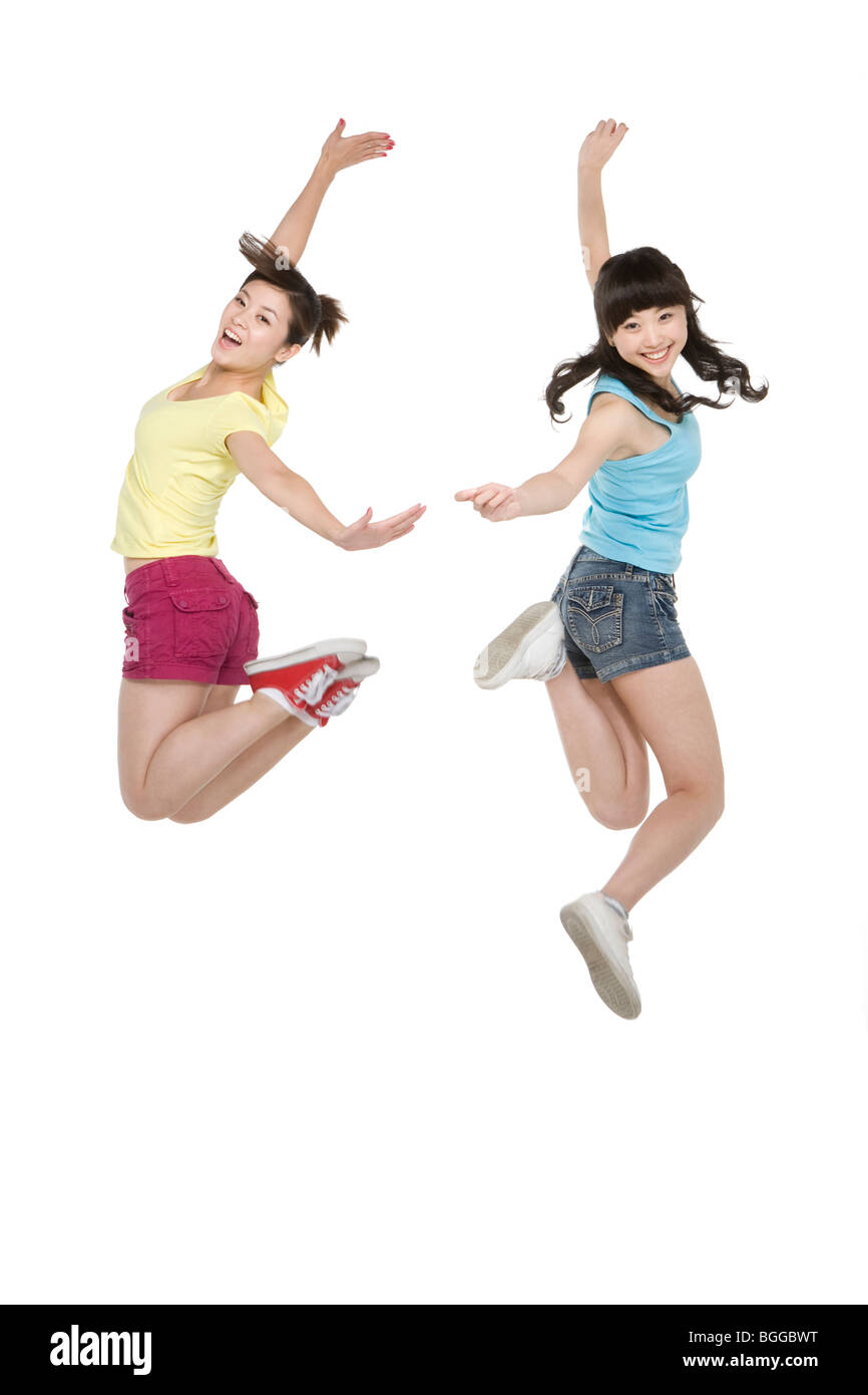 Young women jumping in mid-air Stock Photo - Alamy