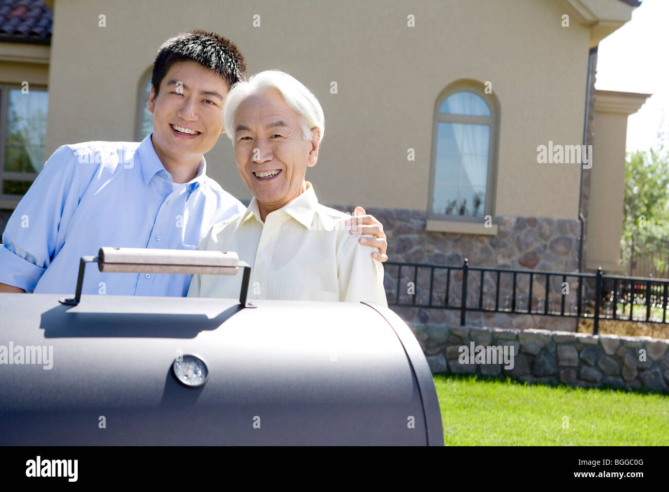 Father and son in front of house Stock Photo - Alamy