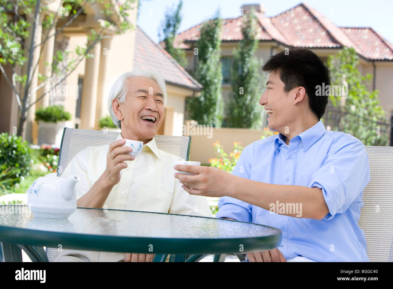 Father and son chatting and having tea Stock Photo - Alamy