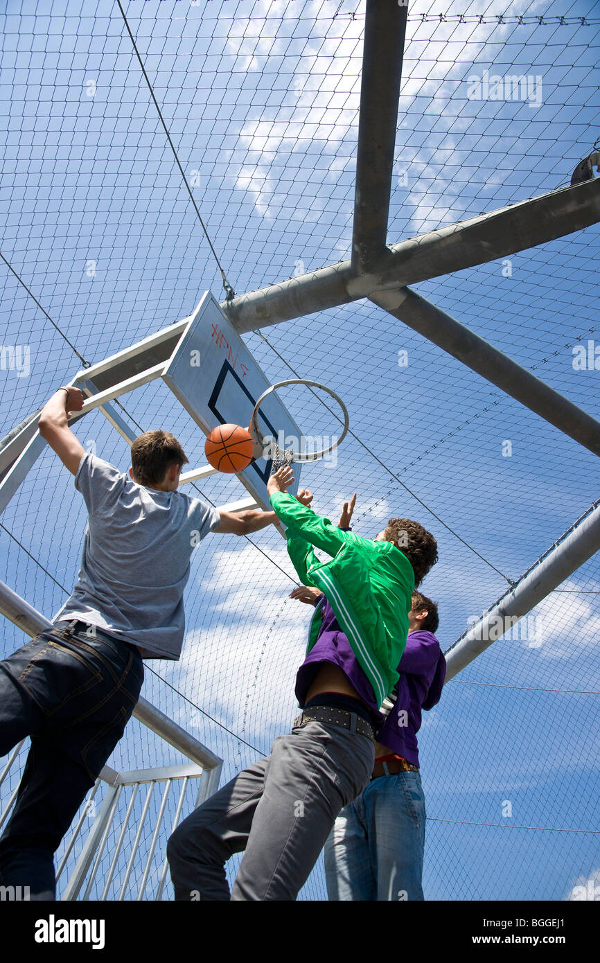 Boys playing basketball, low angle view Stock Photo - Alamy
