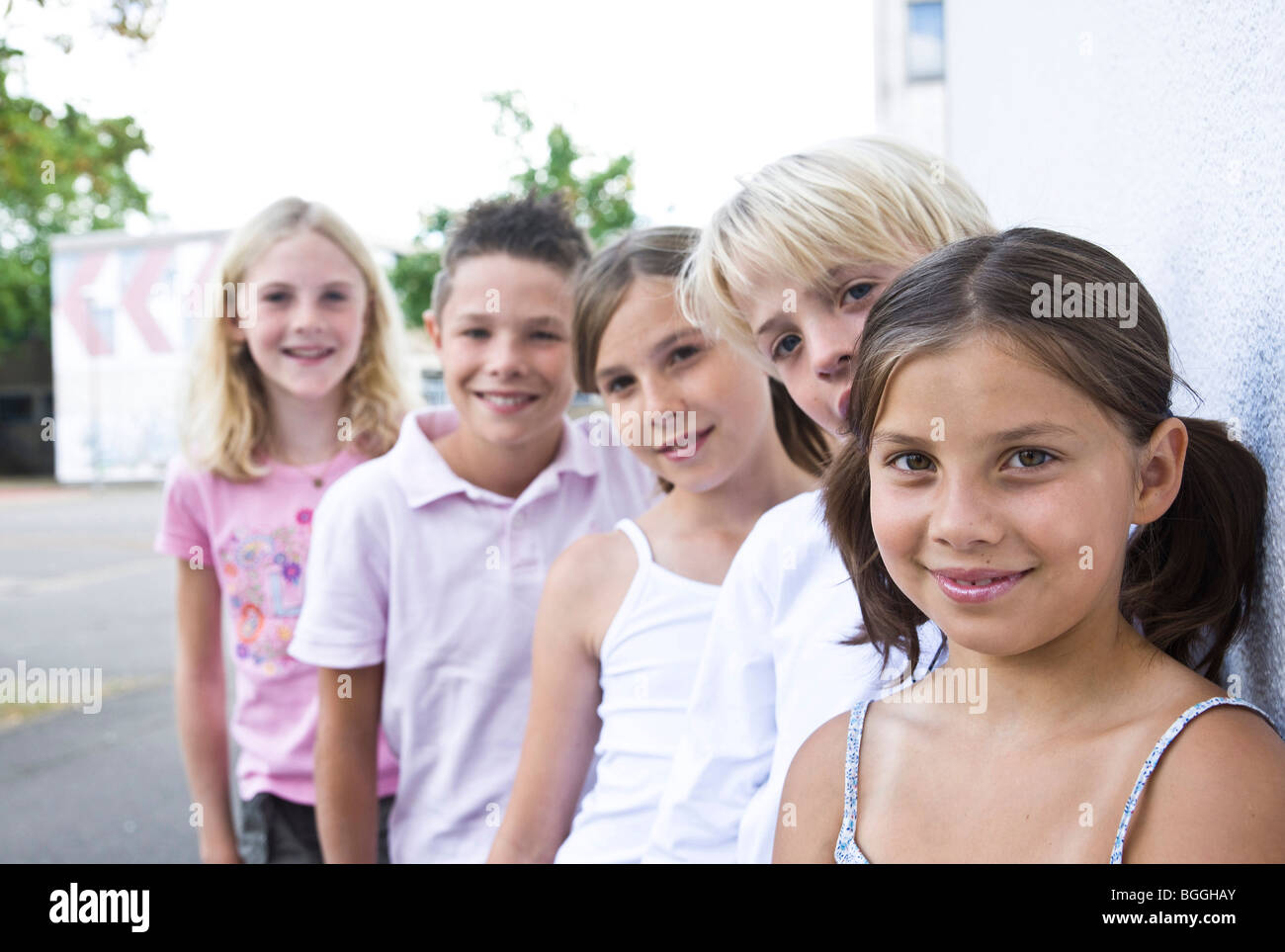 Children standing in a row, front view Stock Photo - Alamy
