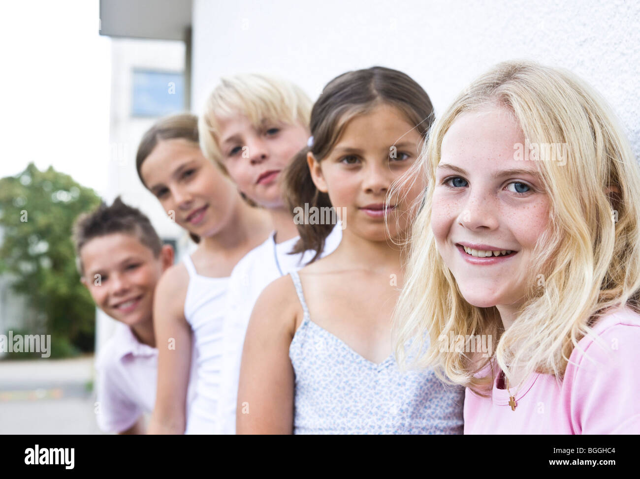 Children standing in a row, front view Stock Photo - Alamy