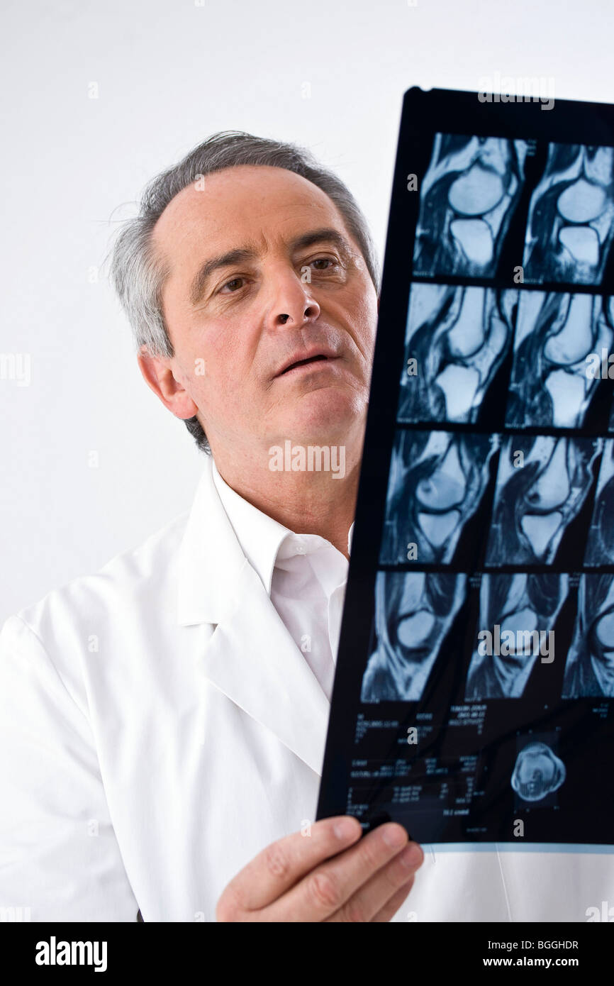 Doctor looking at x-ray image Stock Photo - Alamy