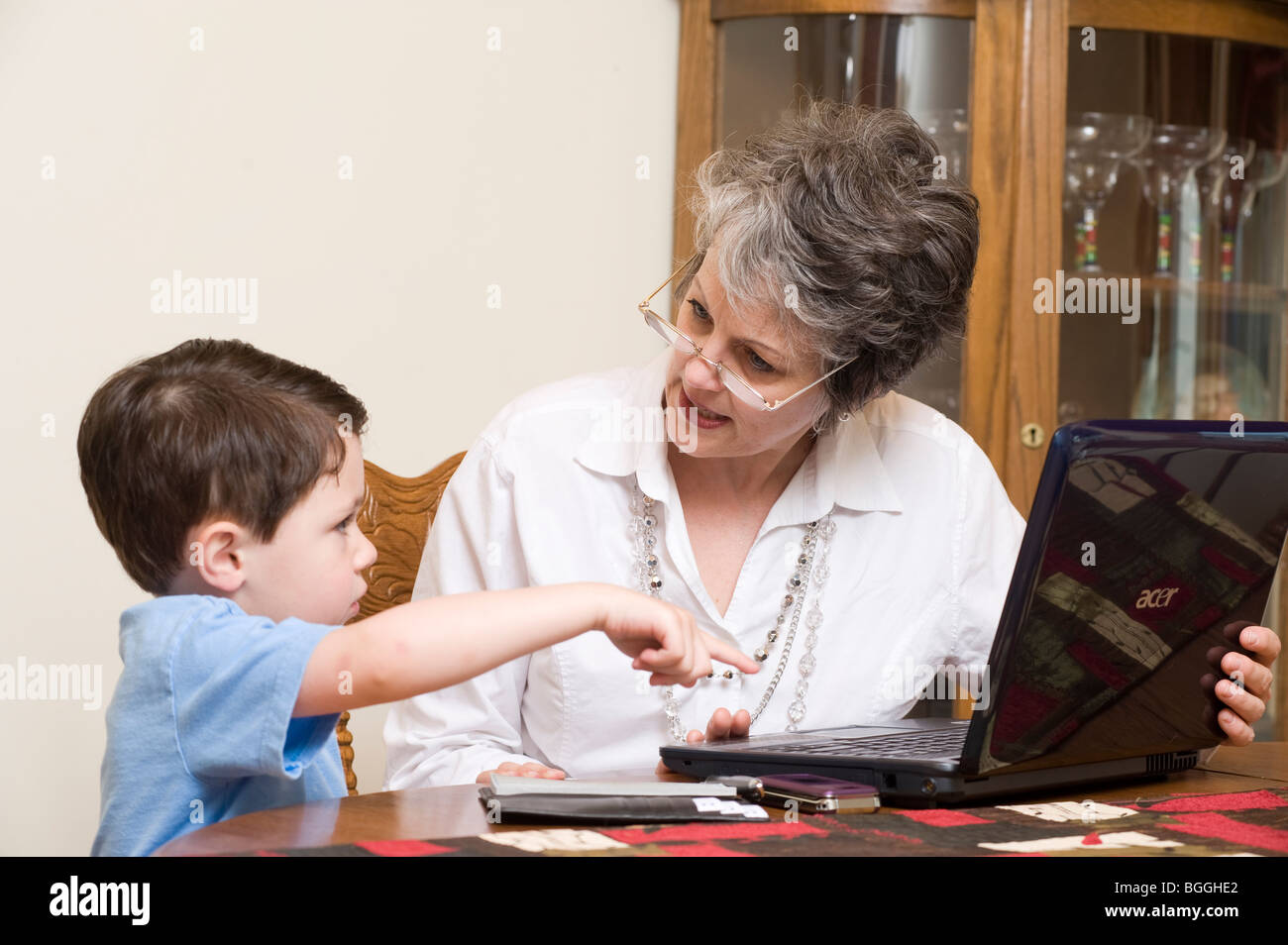 Active senior woman pays household bills online with the help of ...