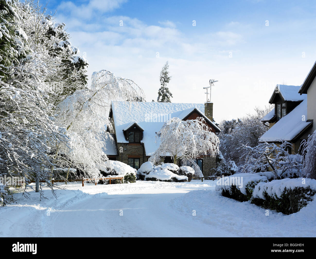 A street view showing a car and houses covered in snow Stock Photo - Alamy
