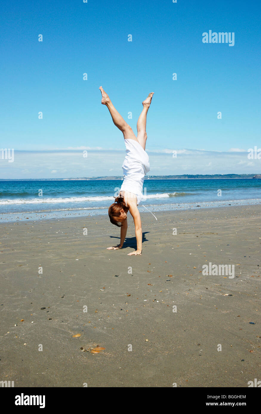 Woman doing handstand beach hi-res stock photography and images - Alamy