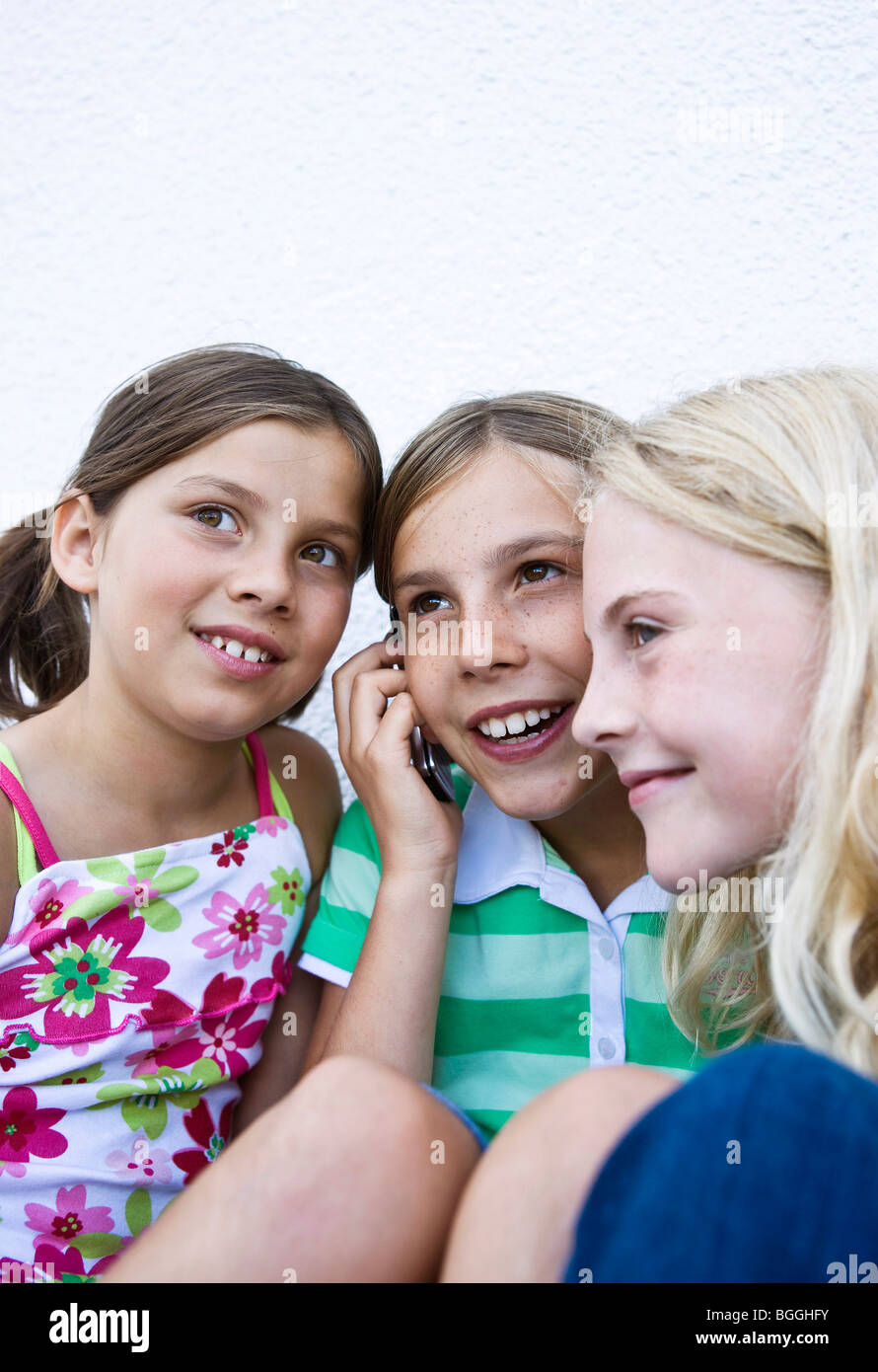Three girls using a mobile phone, close-up Stock Photo - Alamy