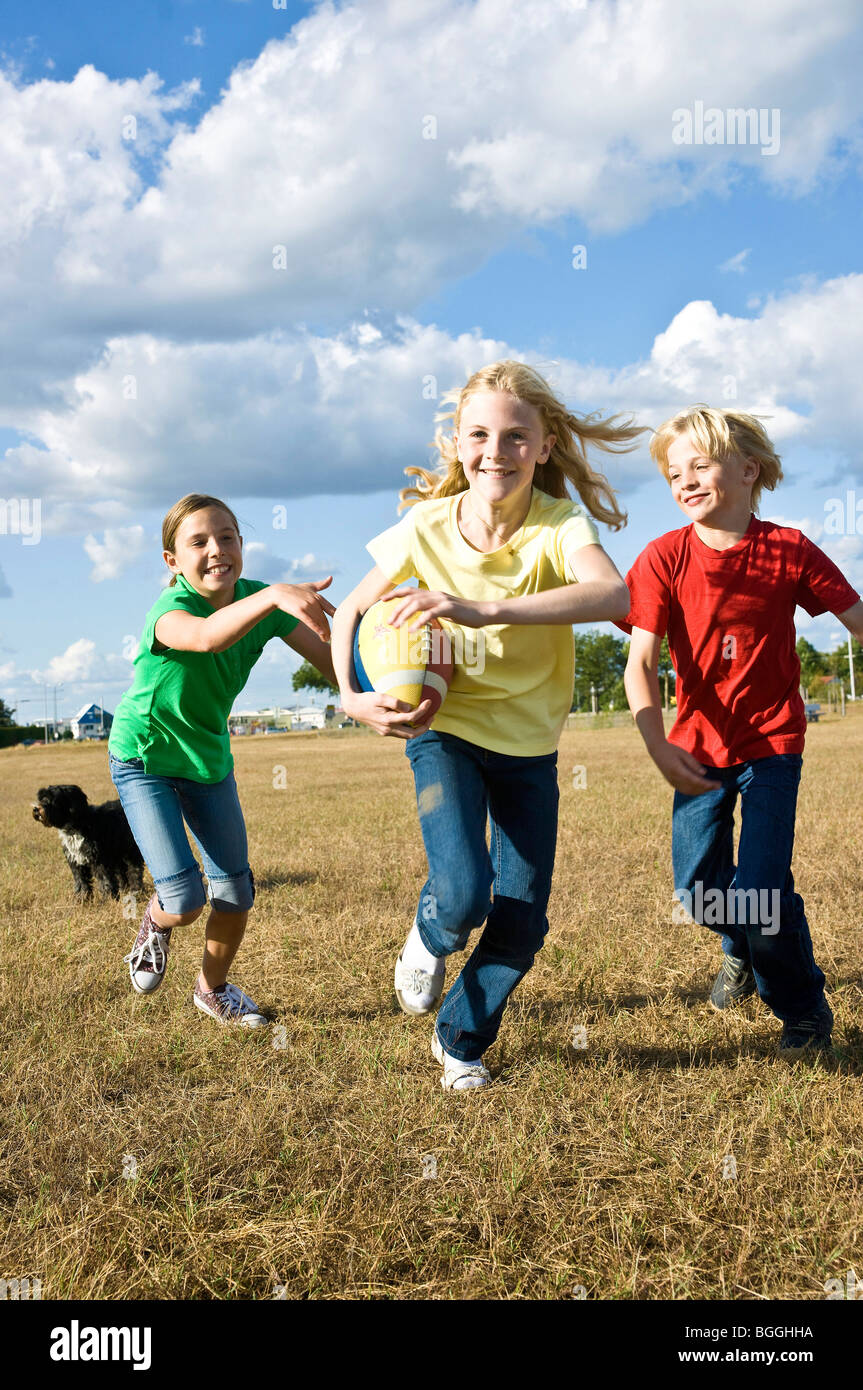 Children running over field, front view Stock Photo - Alamy