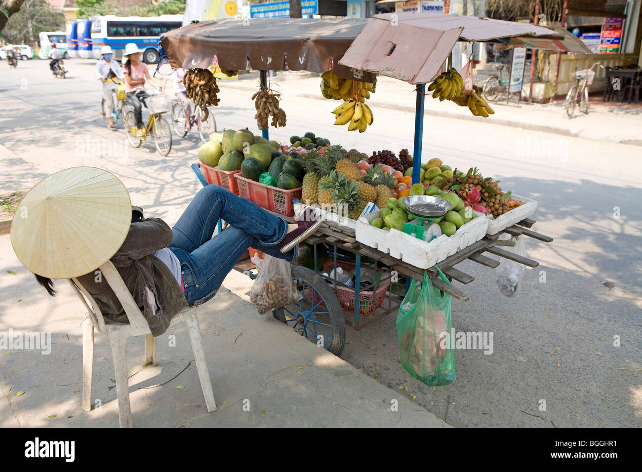 Salesperson at a fruit stand on a street, Hoi An, Vietnam Stock Photo ...