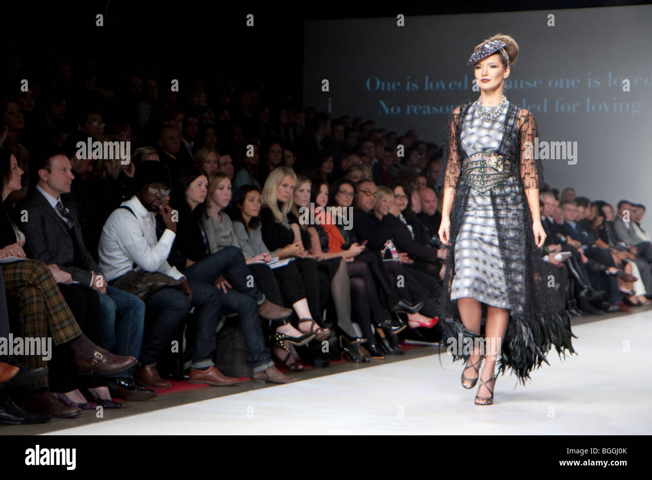 Female models wearing fashion designs walking on the runway with an ...