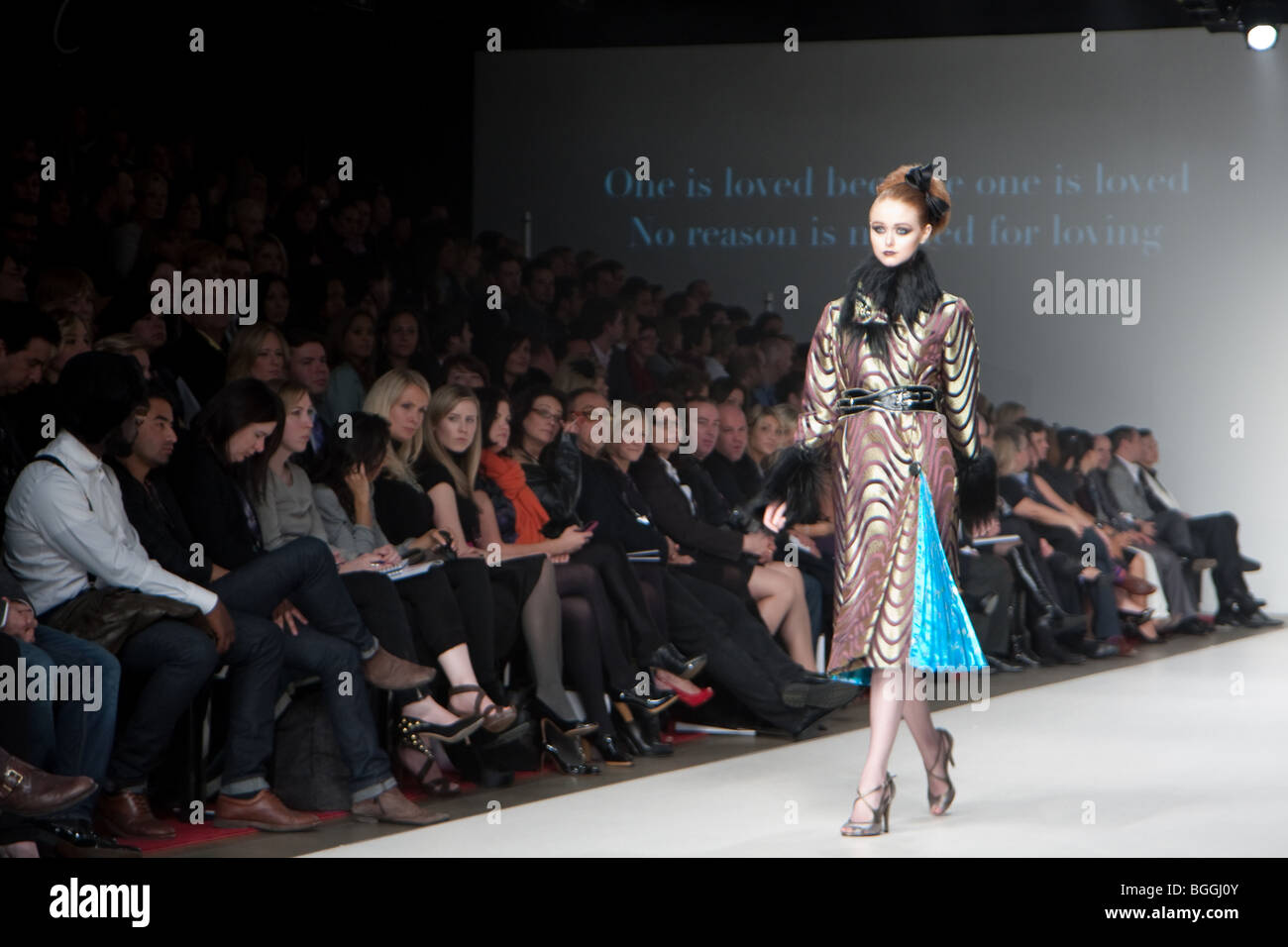 Female models wearing fashion designs walking on the runway with an ...