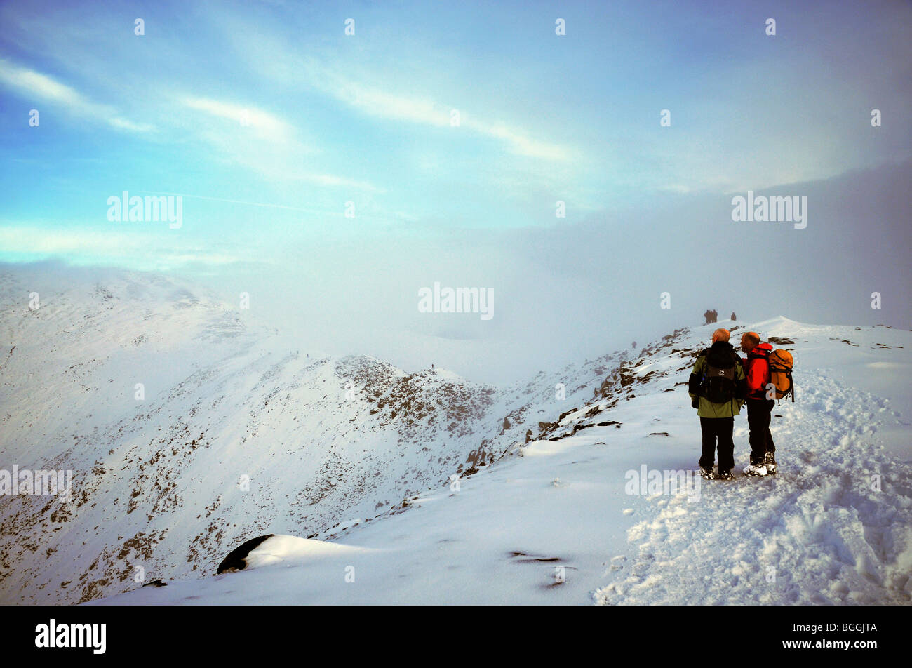 Walkers and clearing mist seen from Carnedd Dafydd looking towards ...