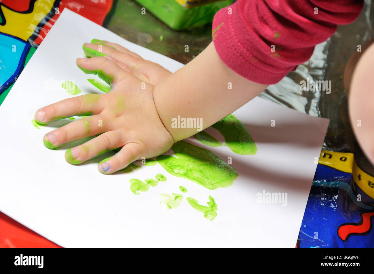 Stock photo of a 3 year old girl doing some creative hand painting play ...