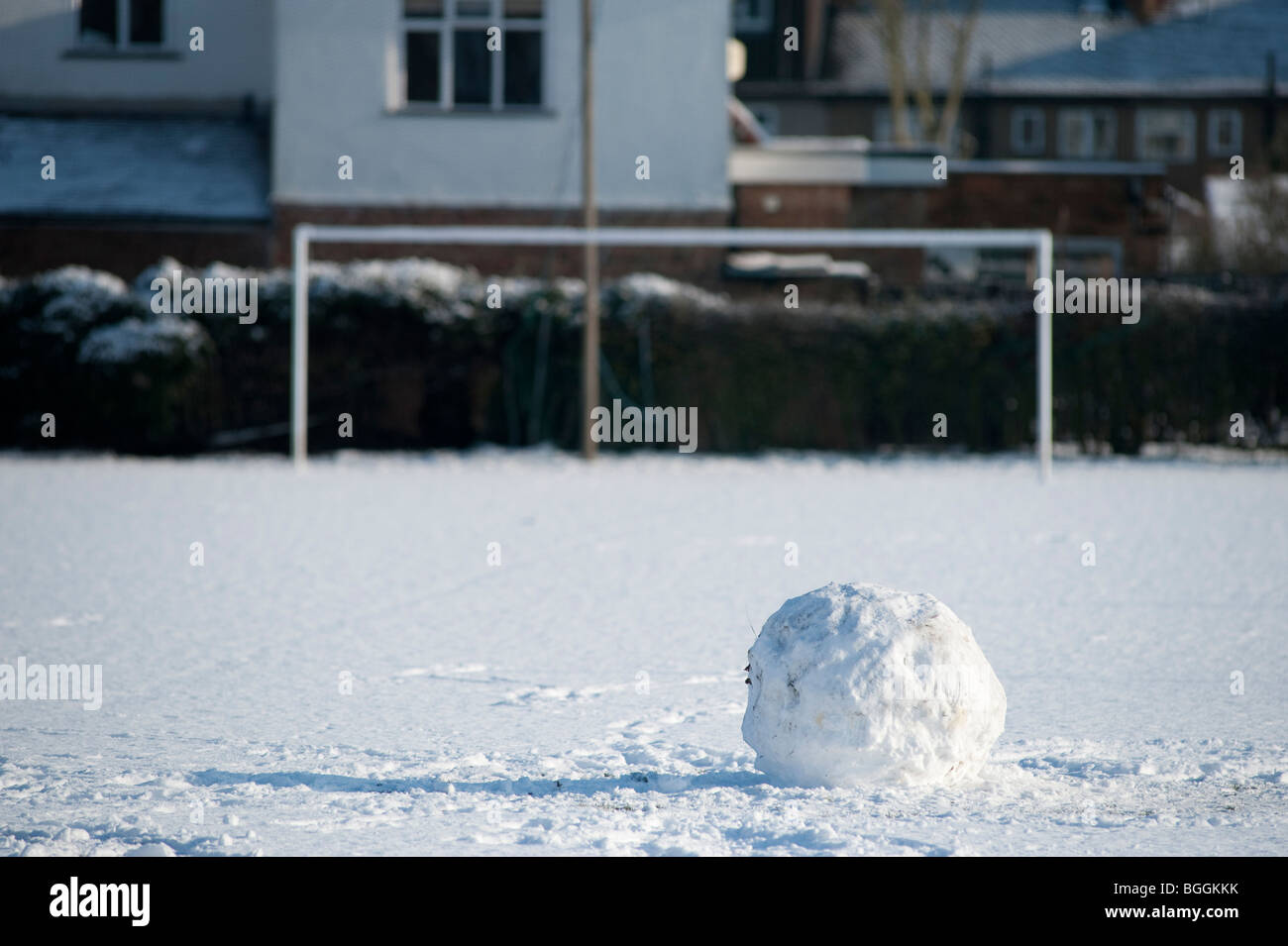 Giant snowball on football pitch with goal mouth Stock Photo - Alamy