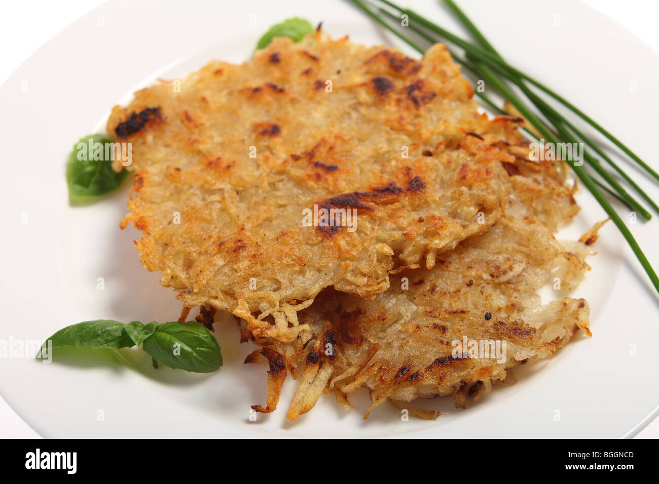 Traditional rosti potatoes in the Swiss style, garnished with chives ...