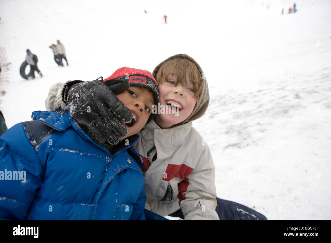 two seven year old boys being silly playing in the snow Stock Photo - Alamy