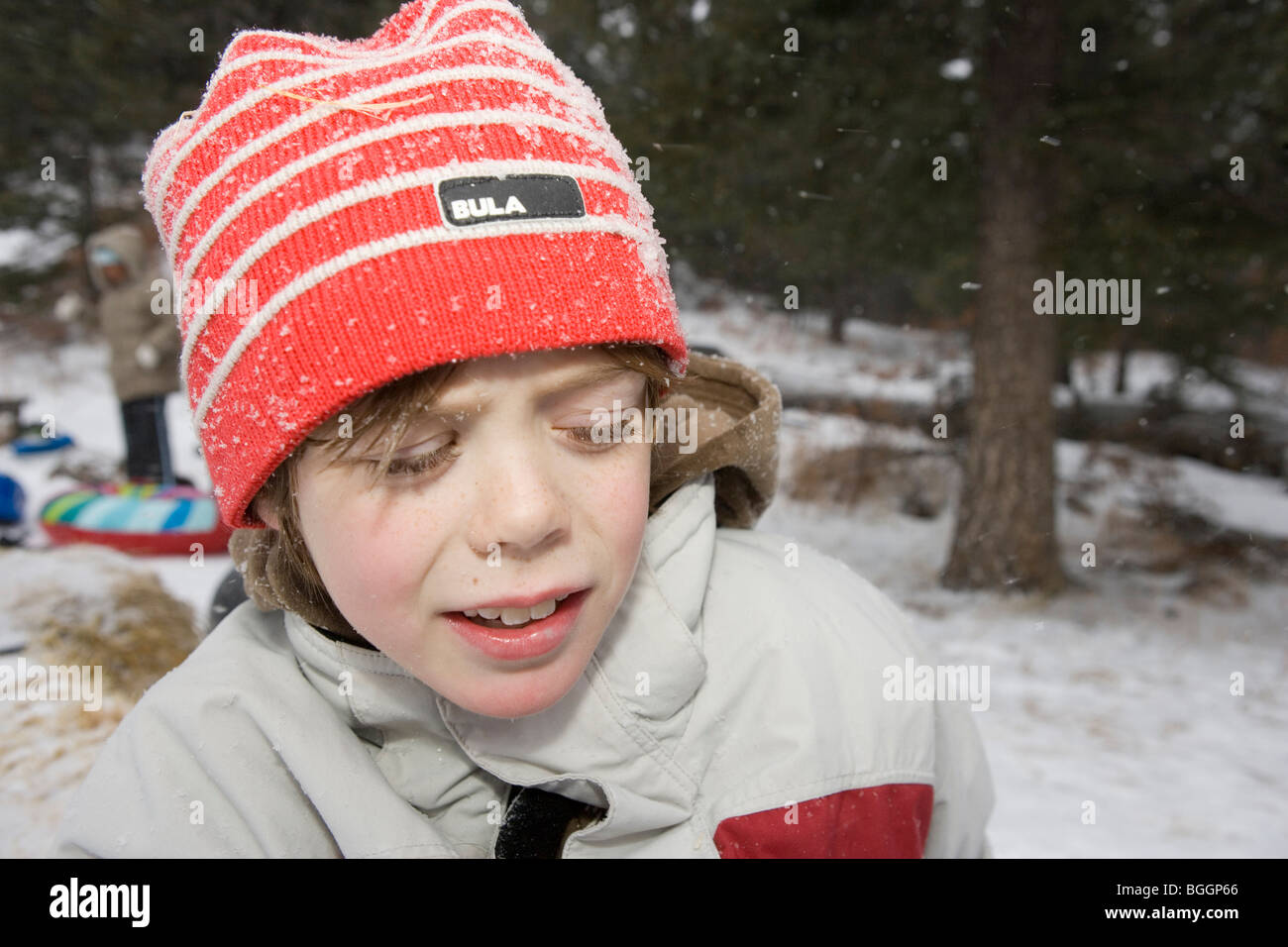 close up of a seven year old boy outdoors in the snow, injured in a ...