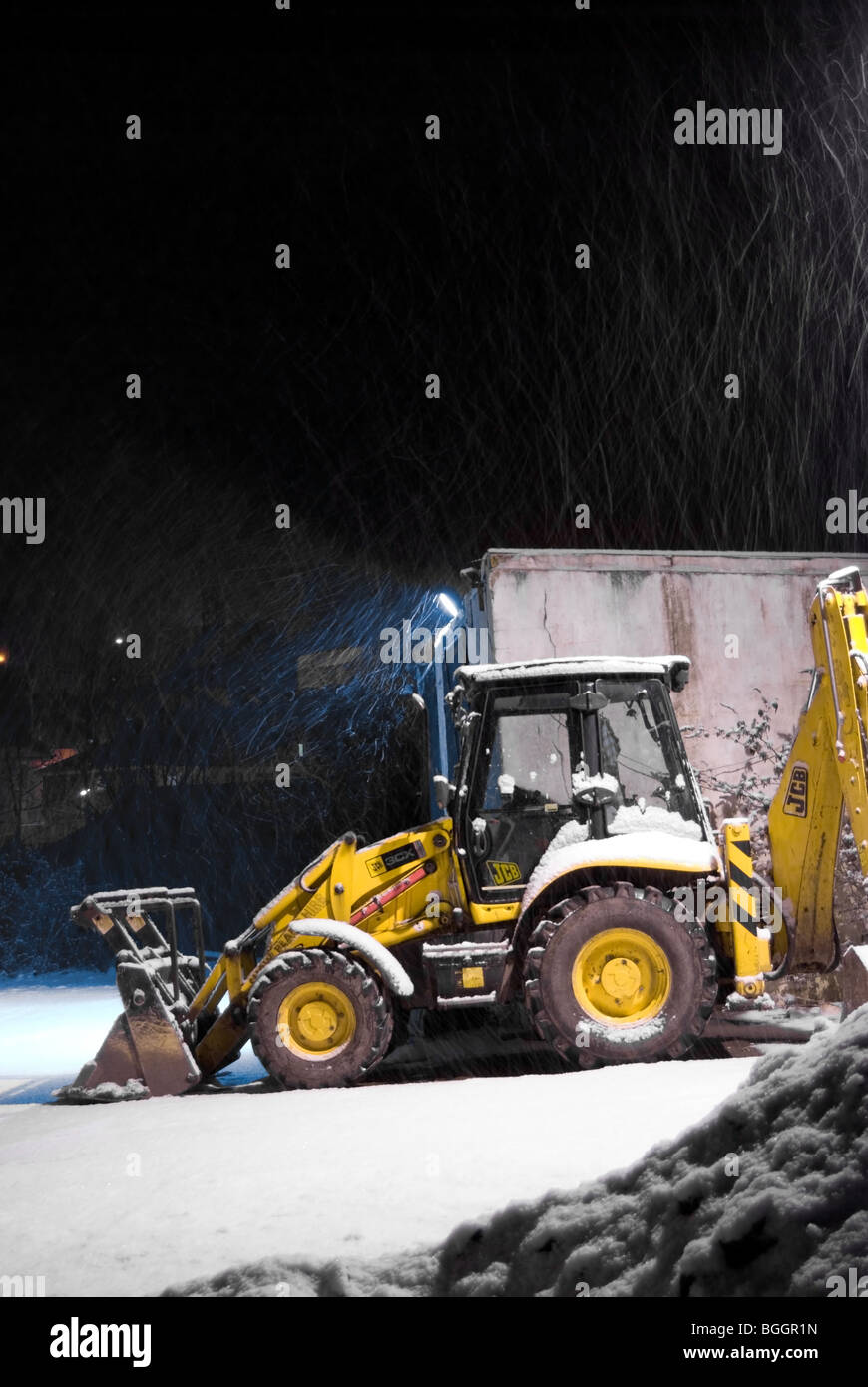 Digger in the snow Stock Photo - Alamy