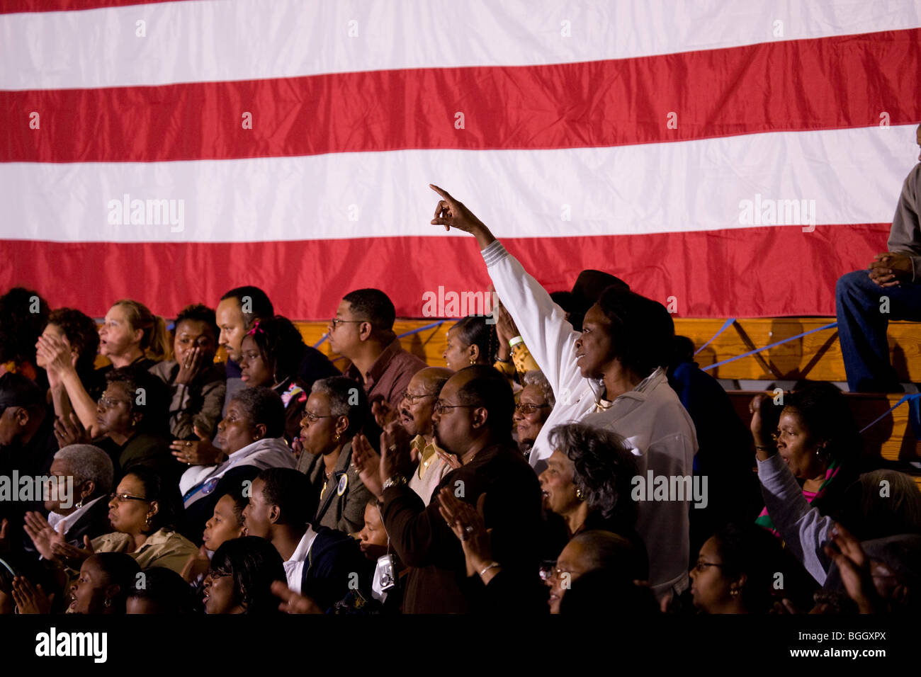 African American woman standing in front of American Flag at Barack ...