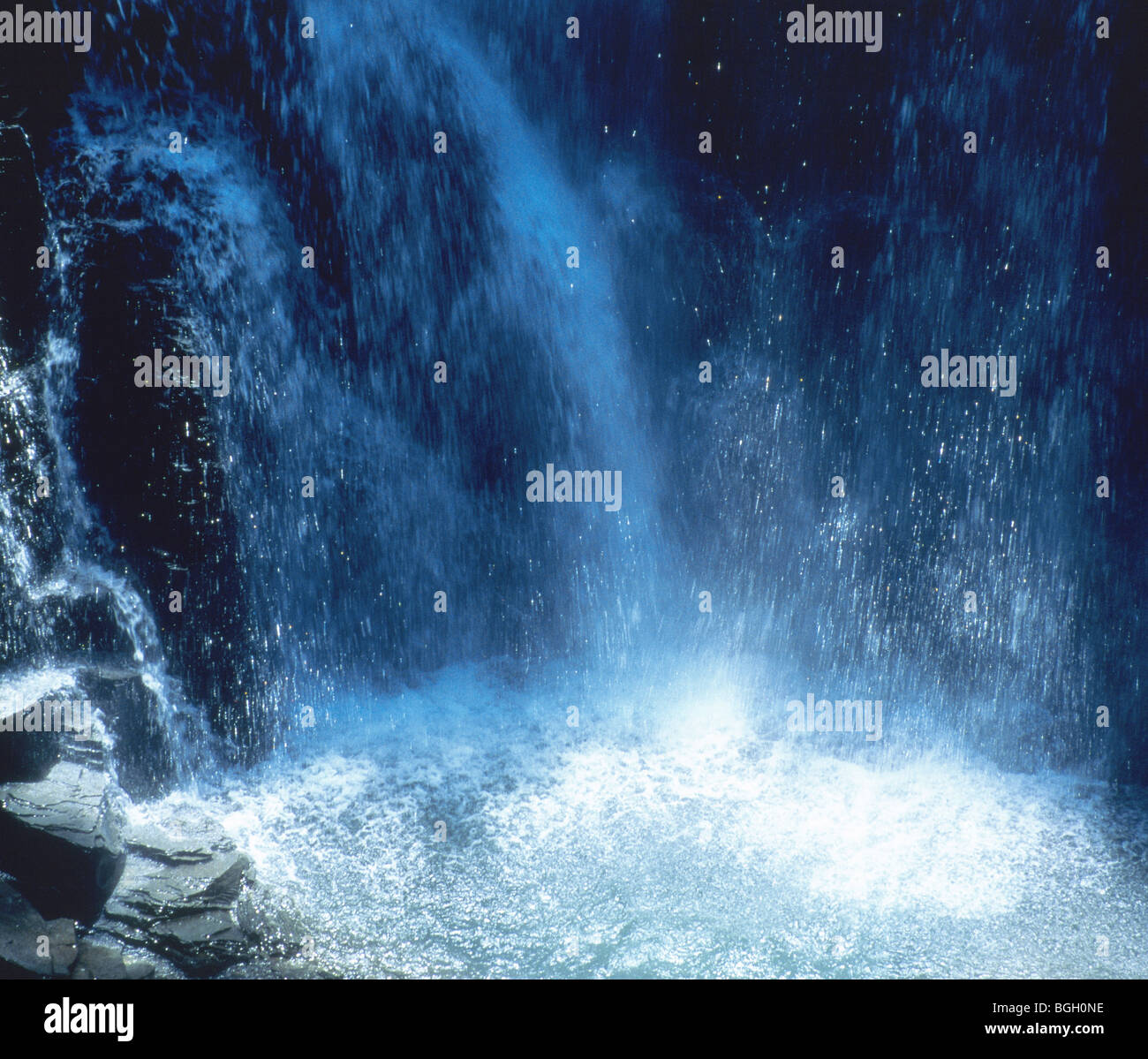 Waterfall cascading into pool Stock Photo - Alamy