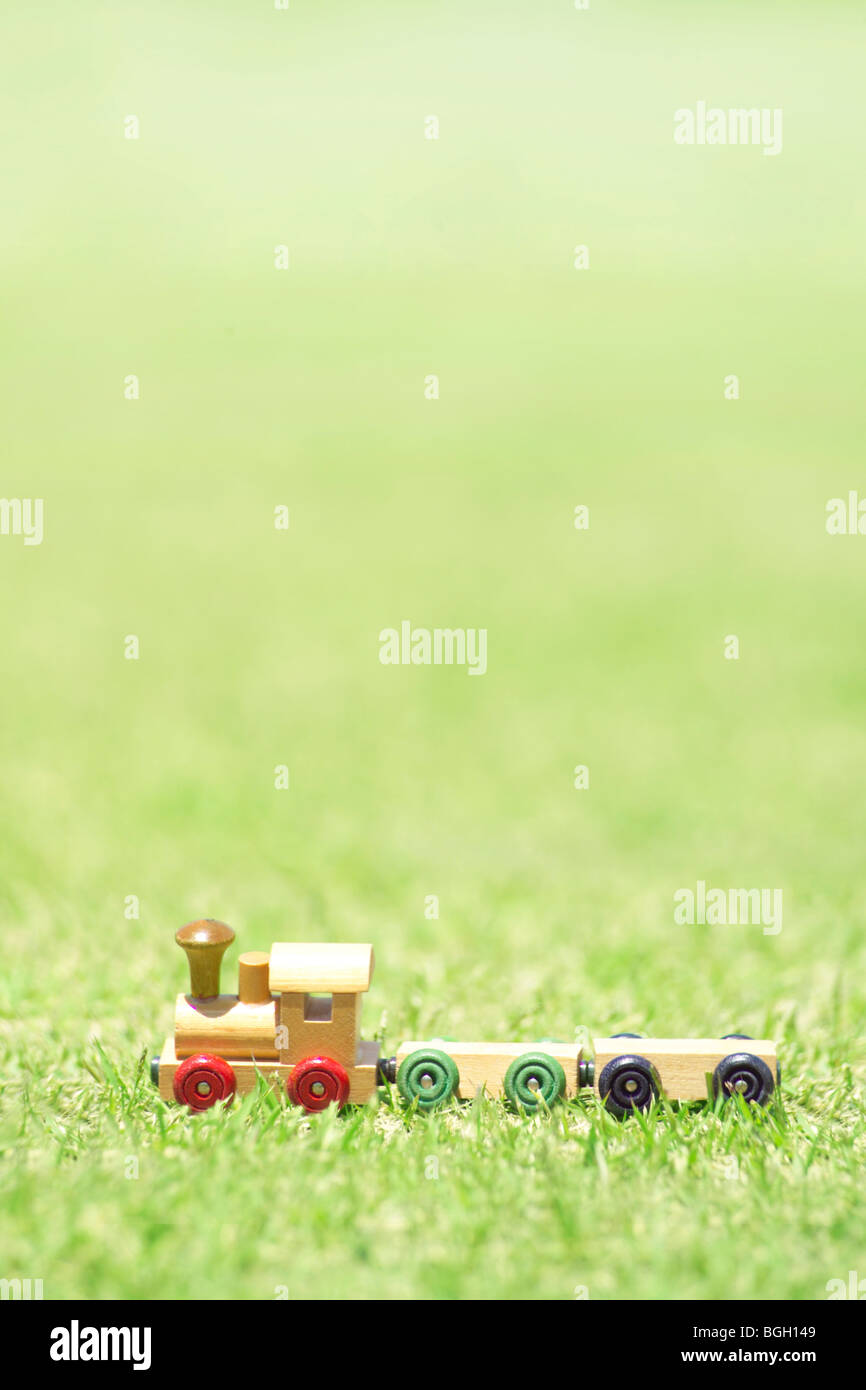 Toy train on a lawn Stock Photo - Alamy