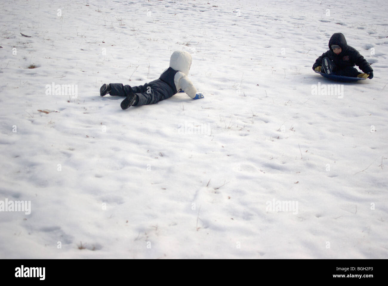 child sliding on snow Stock Photo - Alamy