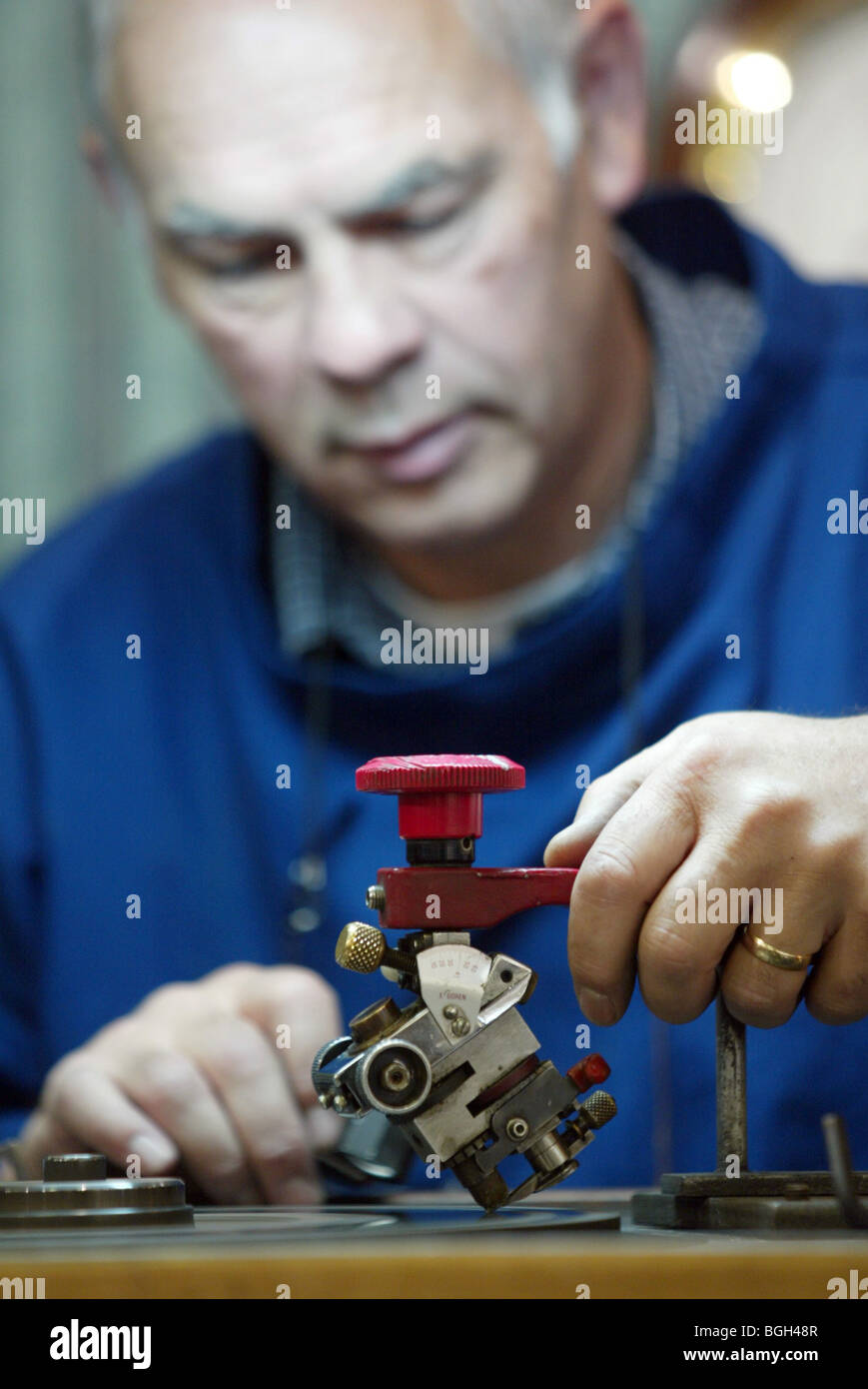 A diamond cutter using the tools of his trade on a diamond Stock Photo ...