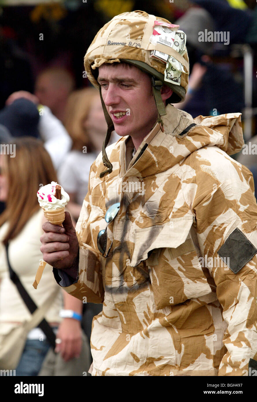 A man in an American soldier desert outfit eating an ice cream Stock ...