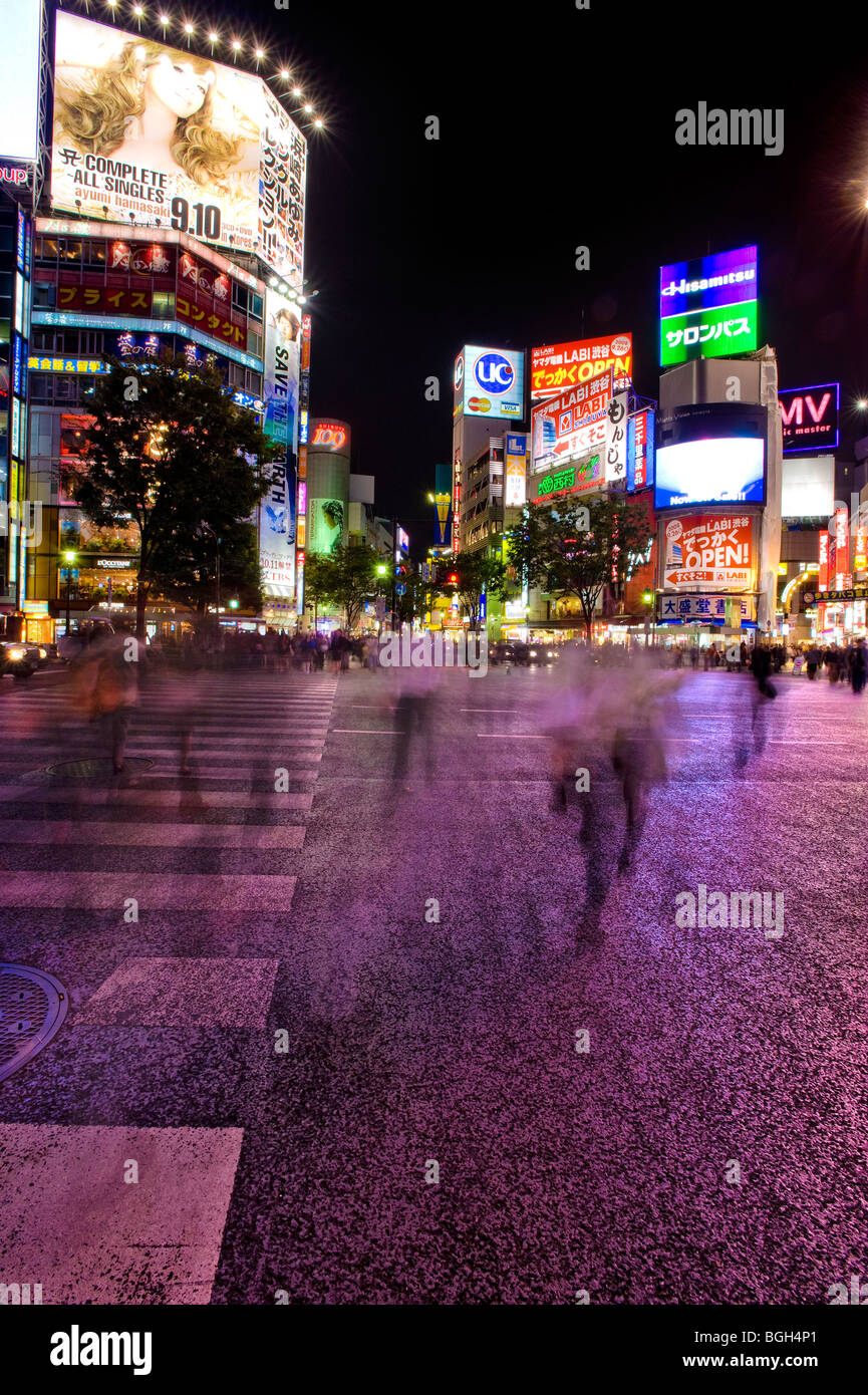 Overview of Shibuya district with pedestrian traffic and neon signs at ...