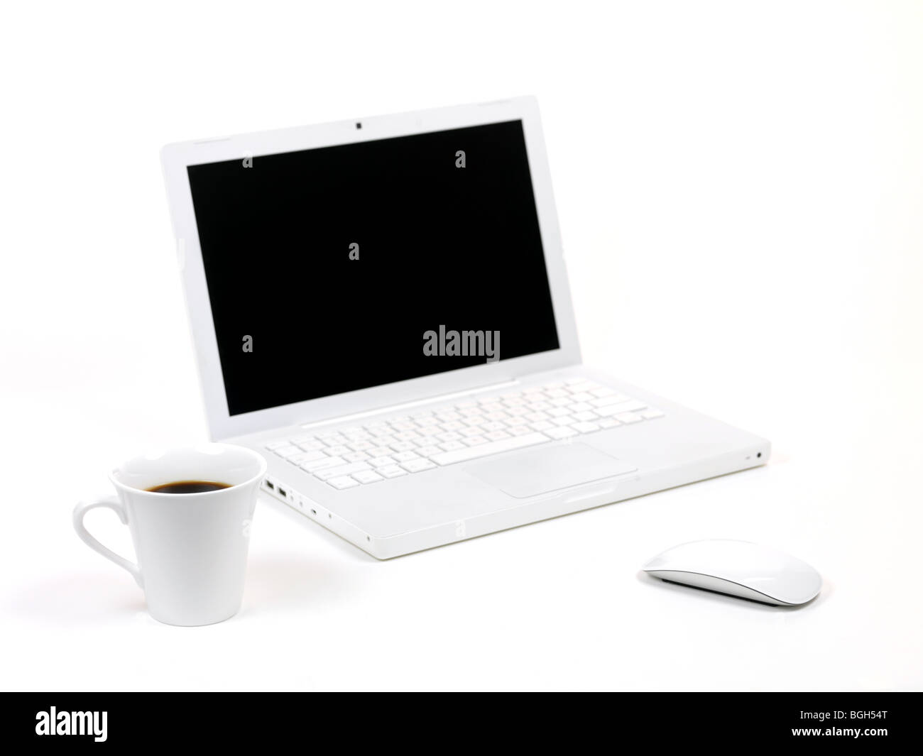A laptop computer and a cup of coffee isolated against a white ...