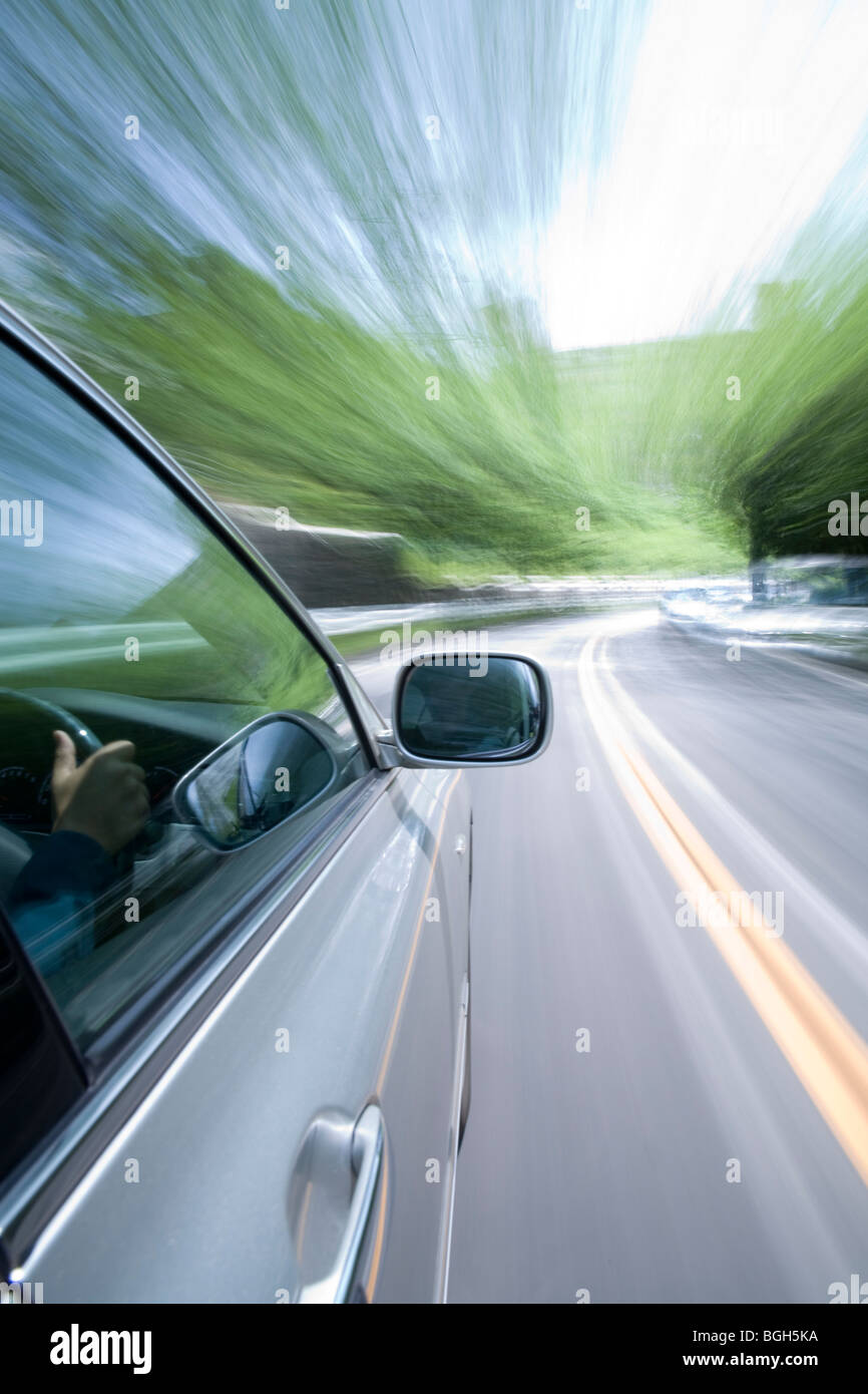 Car driving along a tree lined road Stock Photo - Alamy