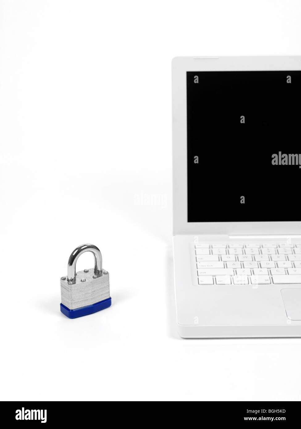 A laptop computer and a padlock isolated against a white background ...