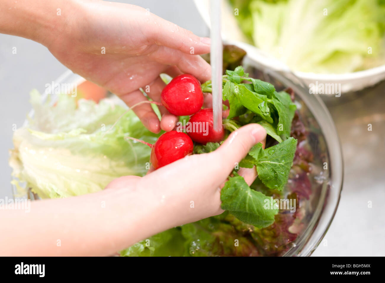 Woman washing radish Stock Photo - Alamy