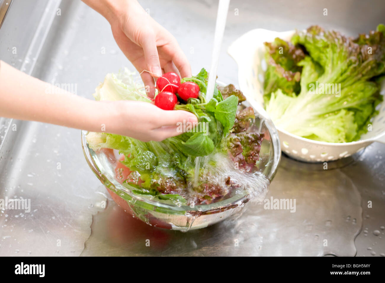 Woman washing radish Stock Photo - Alamy