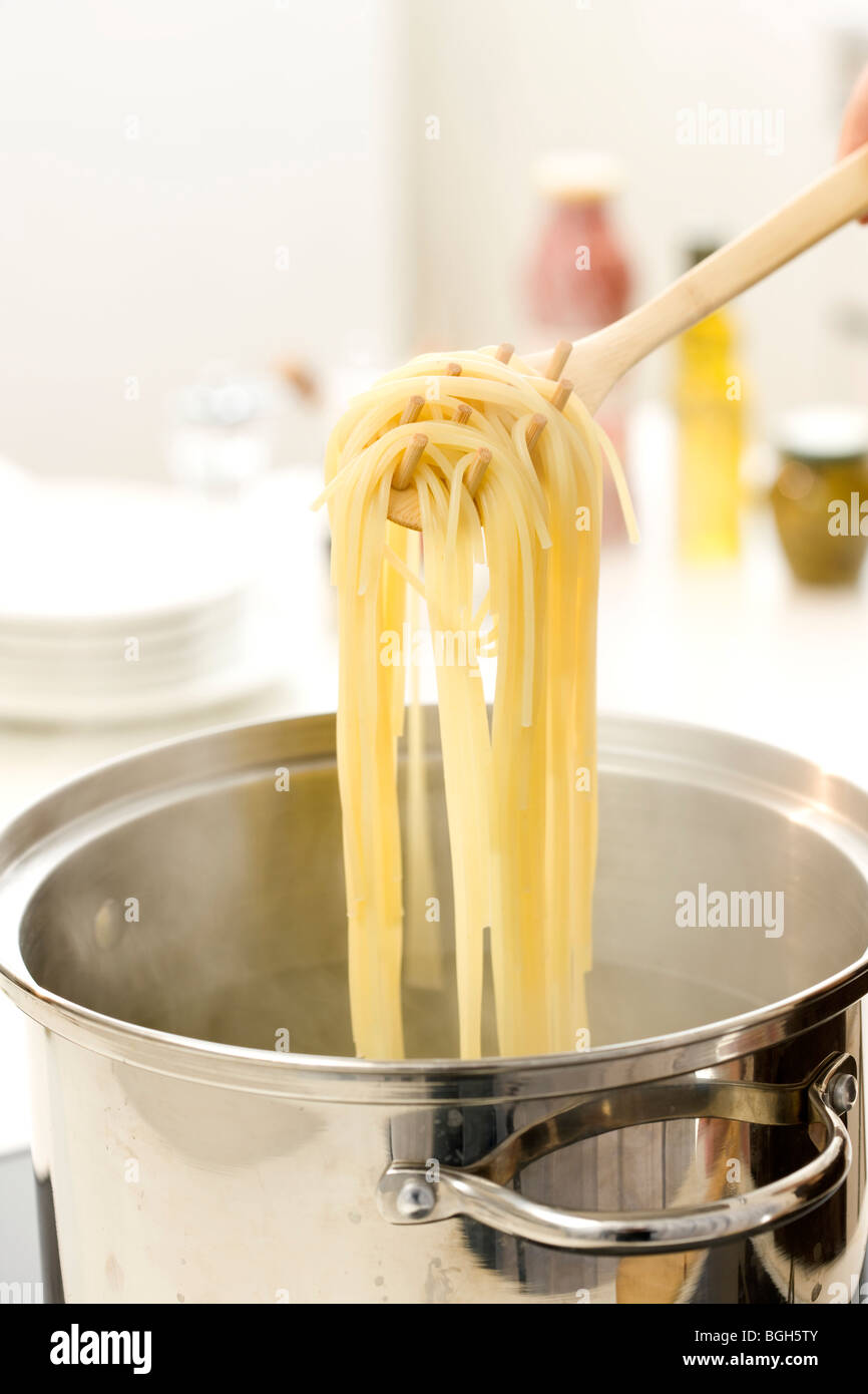 Woman boiling pasta Stock Photo - Alamy