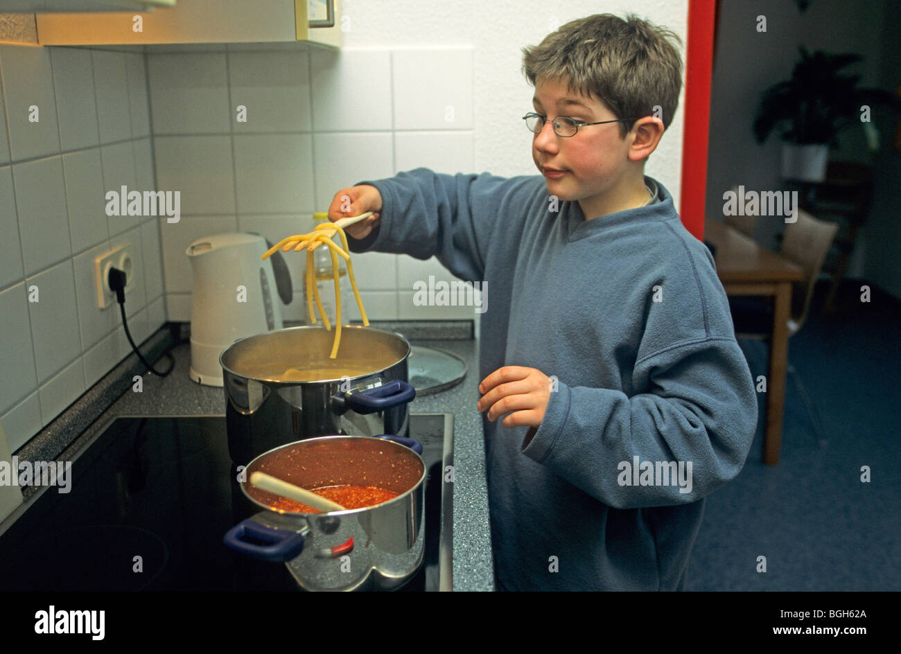 young boy cooking spaghetti Stock Photo - Alamy