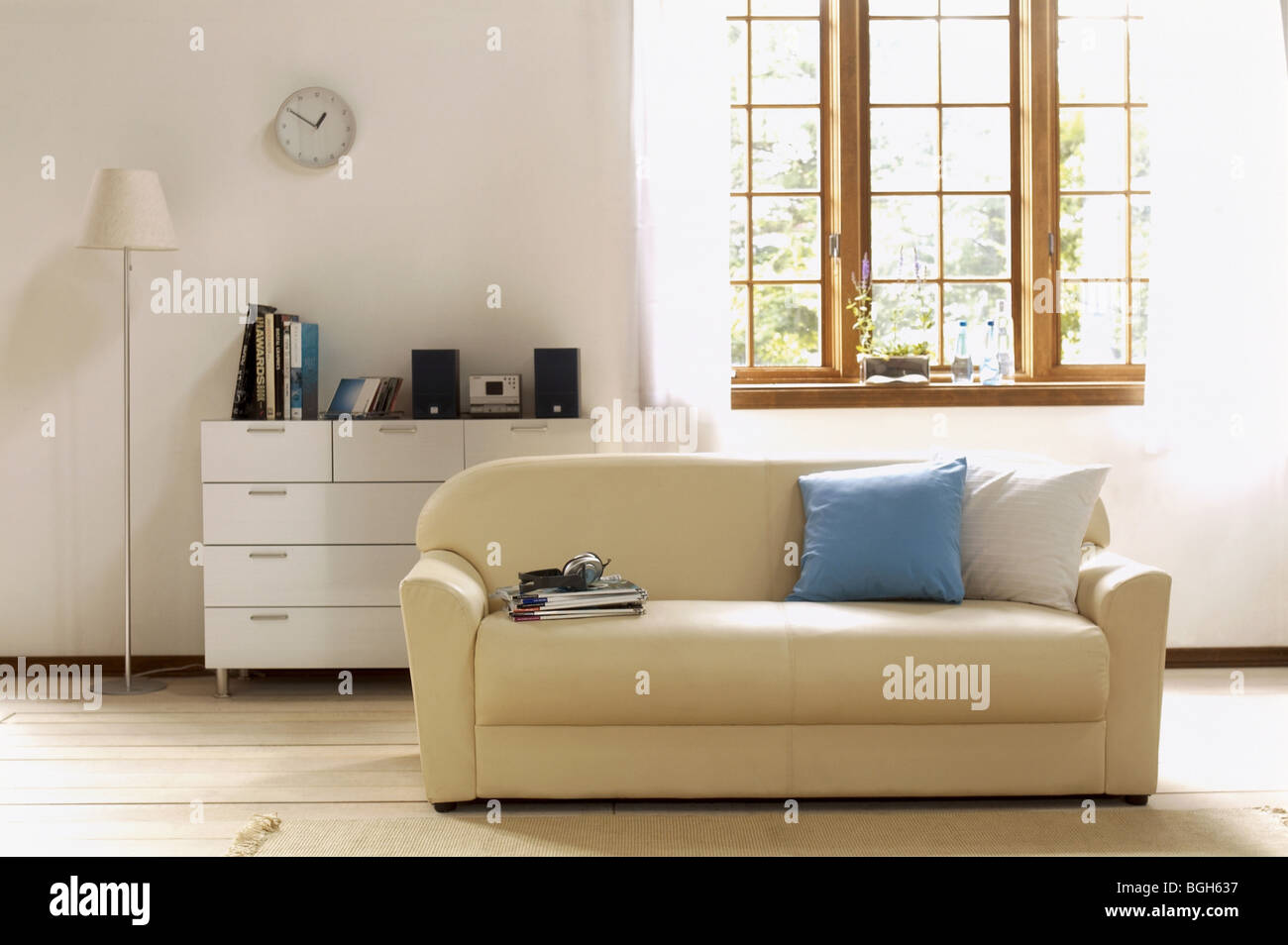 Living room with couch and drawers Stock Photo - Alamy