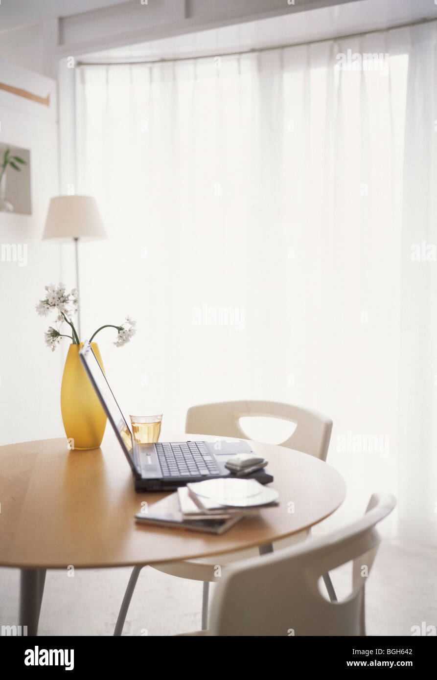 Laptop on table in house Stock Photo - Alamy