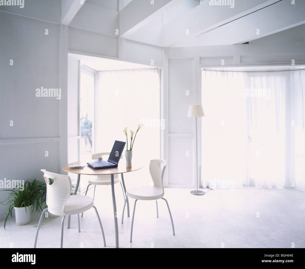 White room with table and laptop Stock Photo - Alamy