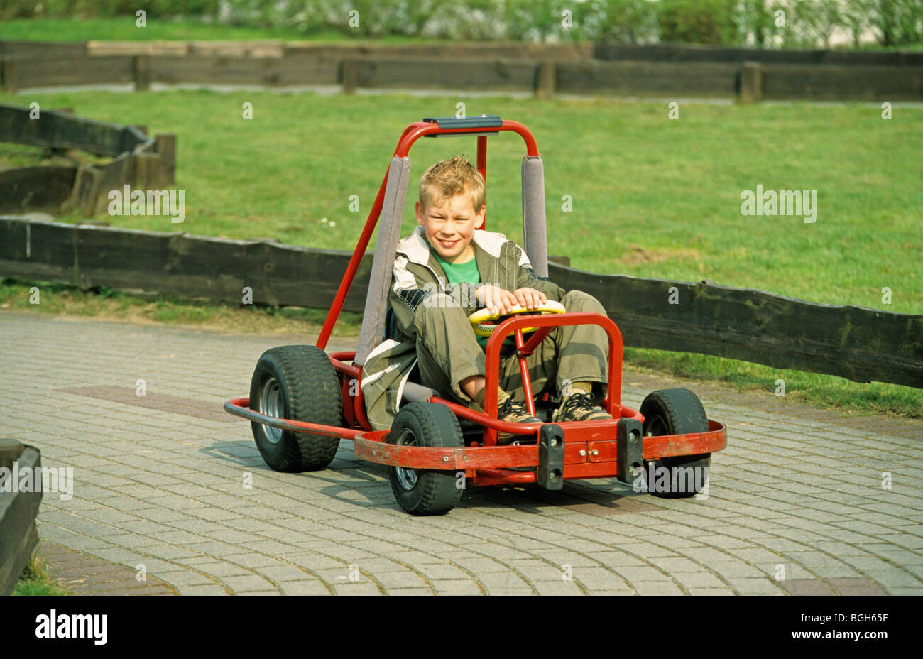 young boy driving a go-cart Stock Photo - Alamy